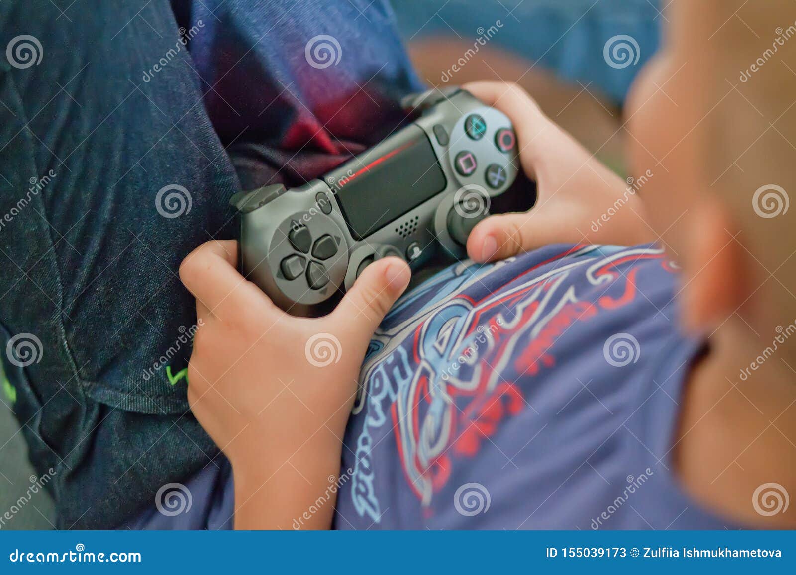 Hands of a Boy Kid Holding a Black Console Pad Controller Joystick and ...