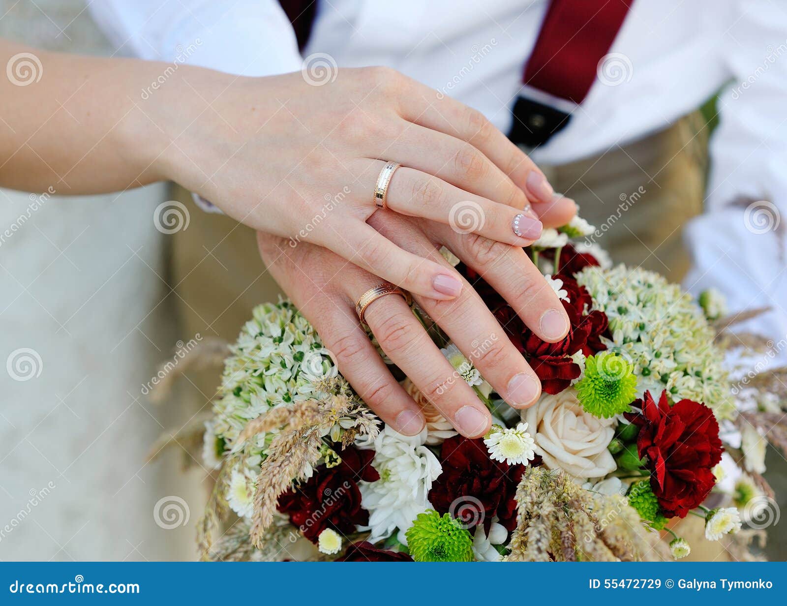 Hands of the Bride and Groom with Rings on Wedding Bouquet Stock Image ...