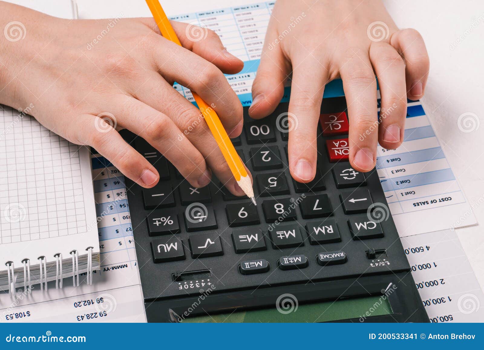 The Hands of a Business Person Count on a Calculator. Report ...