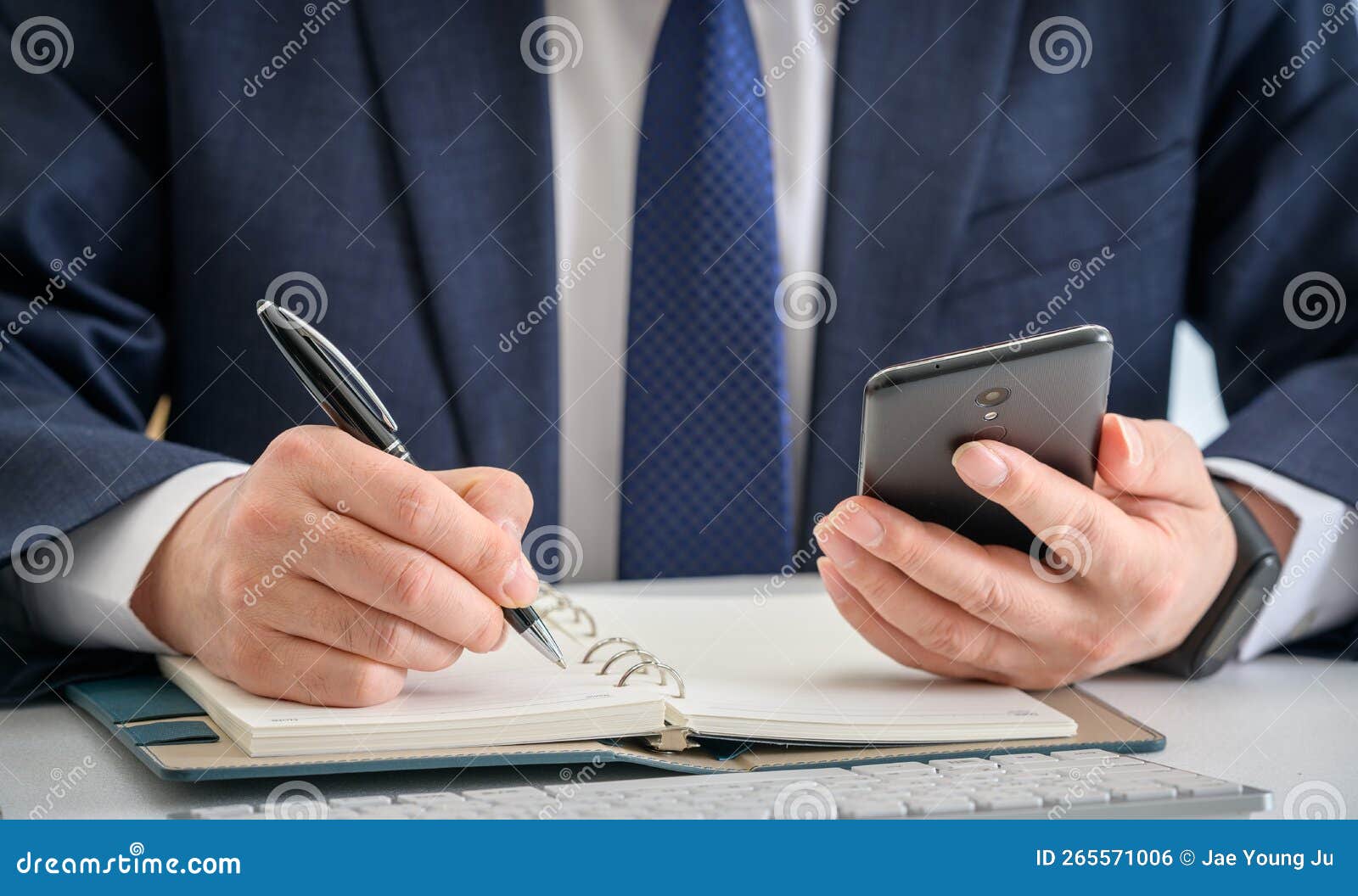 Hands of a Businessman Writing a Schedule or Recording Ideas in a Diary ...