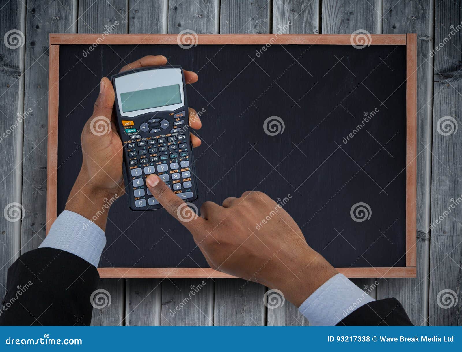 Hands with Calculator Against Chalkboard and Grey Wood Panel Stock ...