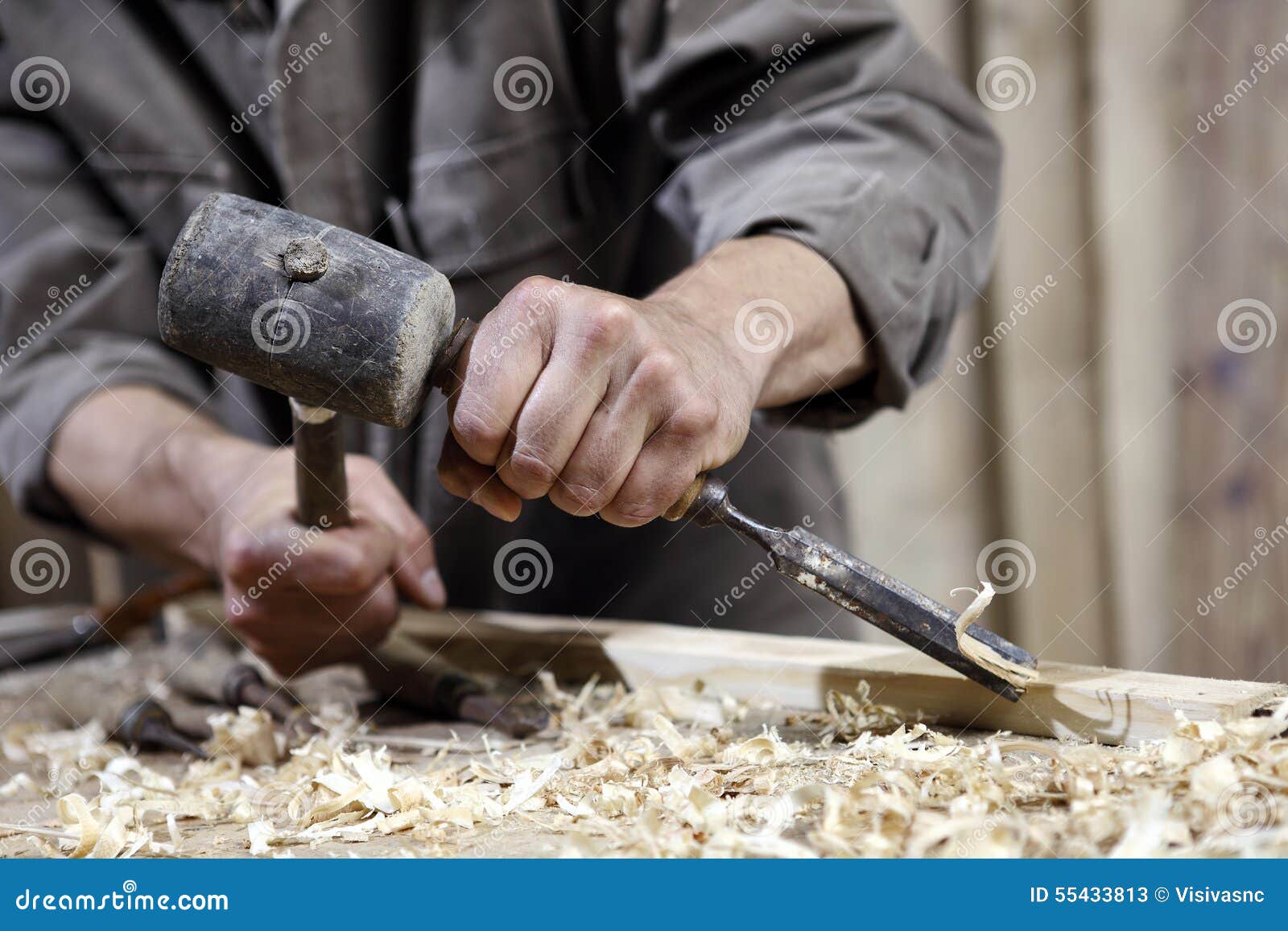 Hands of Carpenter with a Hammer and Chisel on Workbench in Carpentry ...