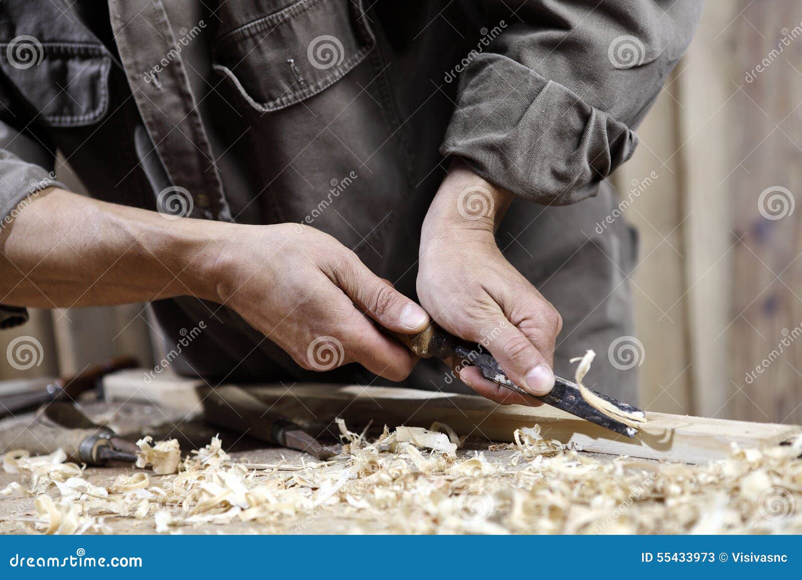 Hands of Carpenter with a Hammer and Chisel on Workbench in Carpentry ...