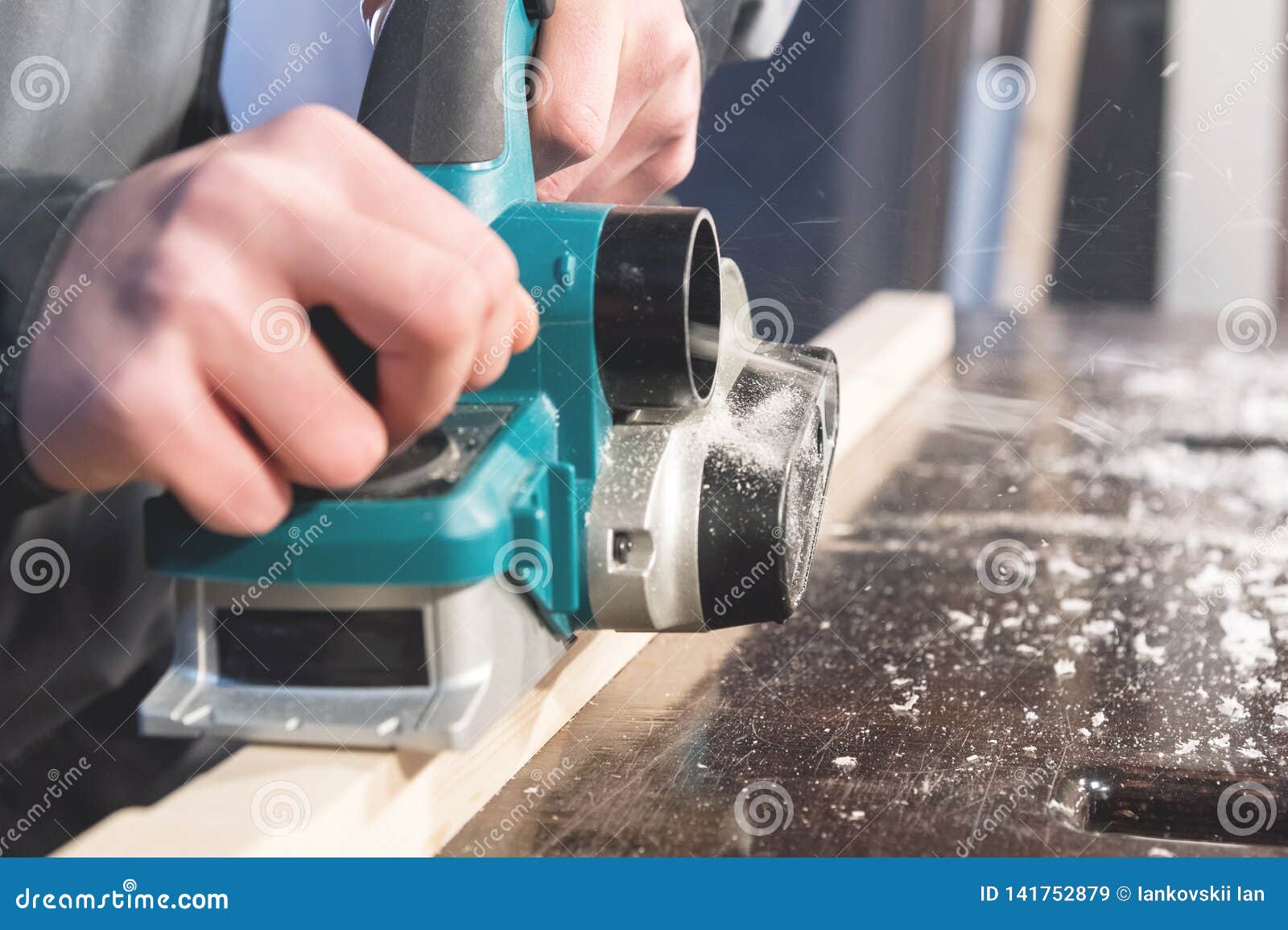 The Hands of a Carpenter Working Woodworking Power Tools. Close Up of ...