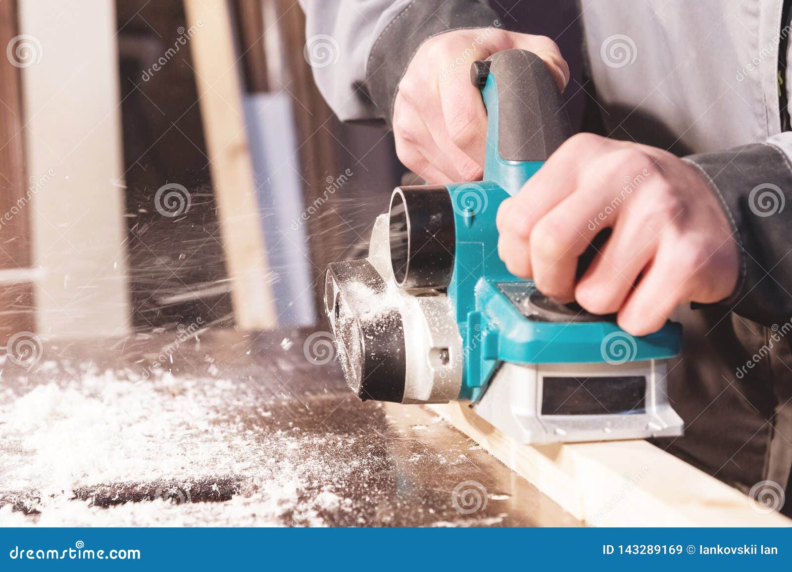 The Hands of a Carpenter Working Woodworking Power Tools. Close Up of ...