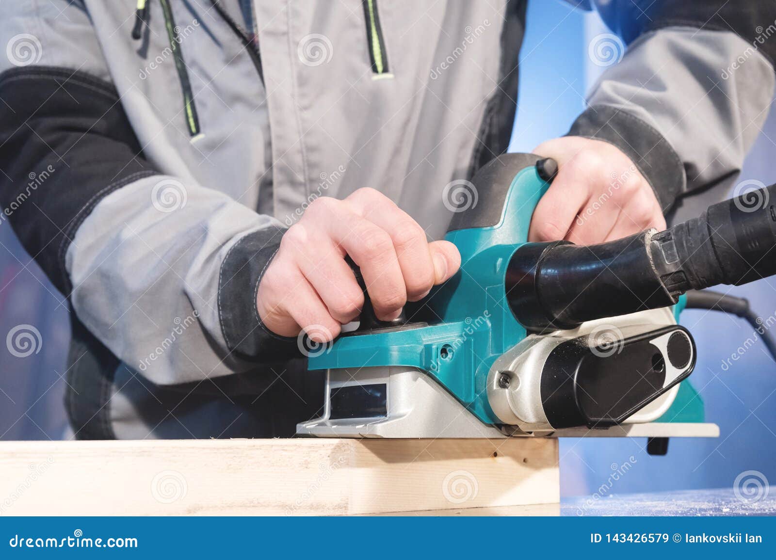 The Hands of a Carpenter Working Woodworking Power Tools. Close Up of ...