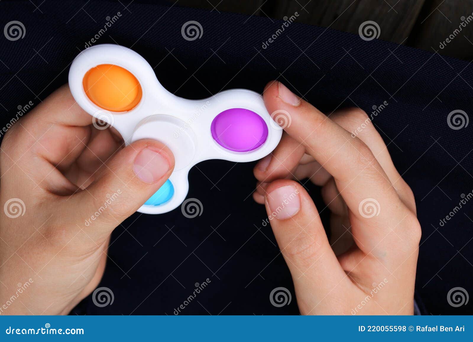 Hands of a Child Playing with Pop it Fidget Spinner Toy Stock Photo ...