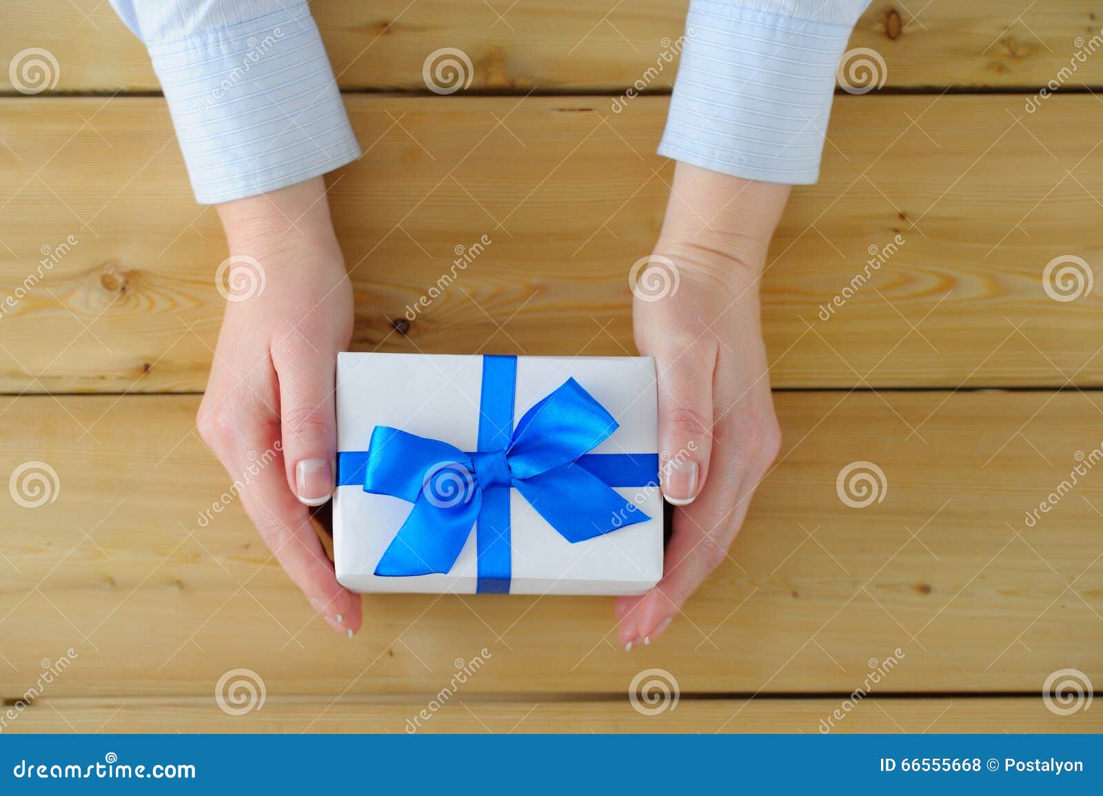 Hands Closeup. Gift with Blue Ribbon in Hands. Stock Photo - Image of ...