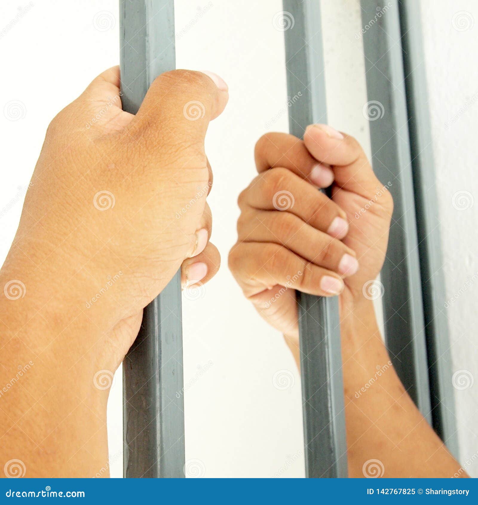 Hands clutching bars stock image. Image of building - 142767825