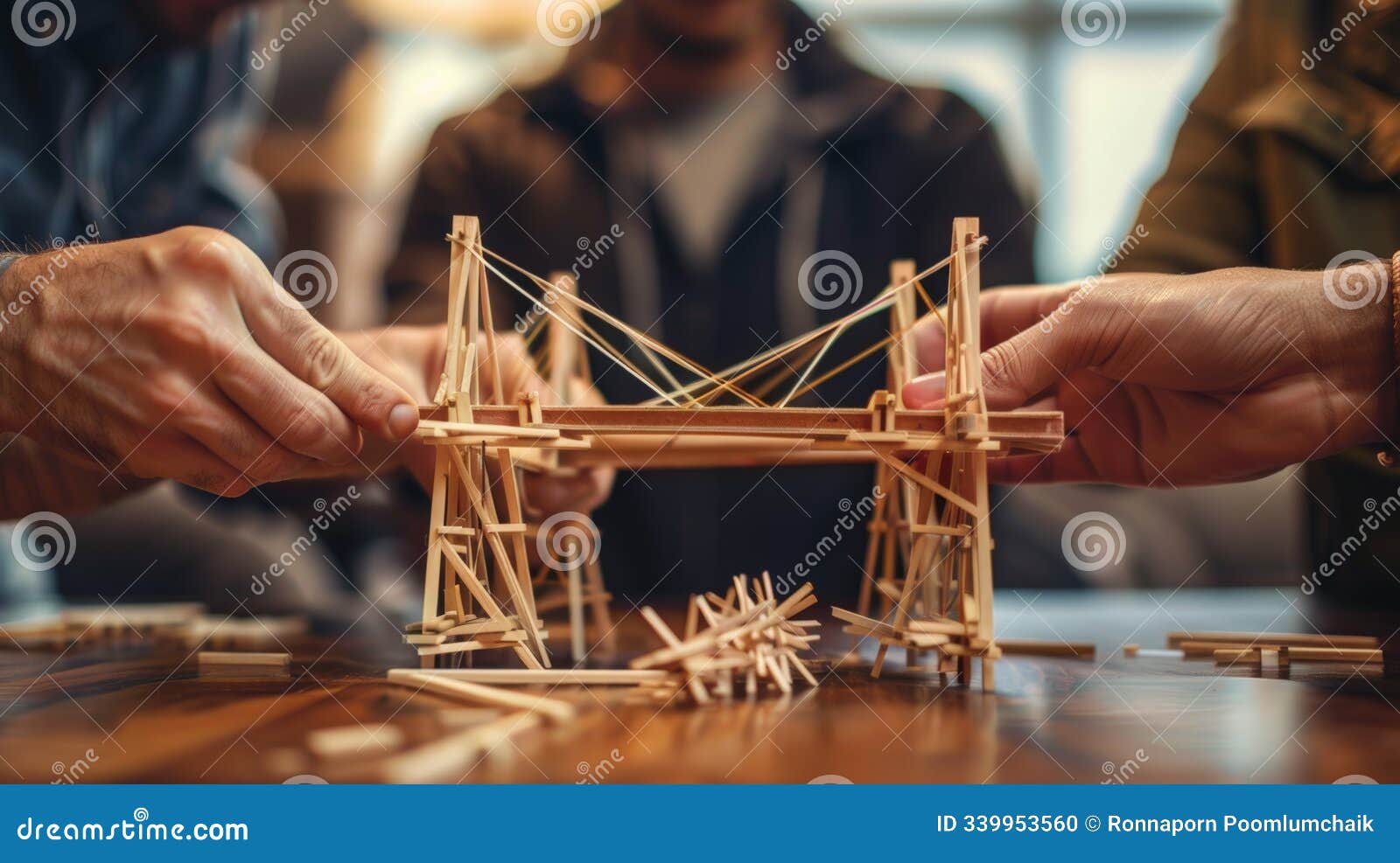 Hands Collectively Building a Miniature Bridge with Tiny Construction ...