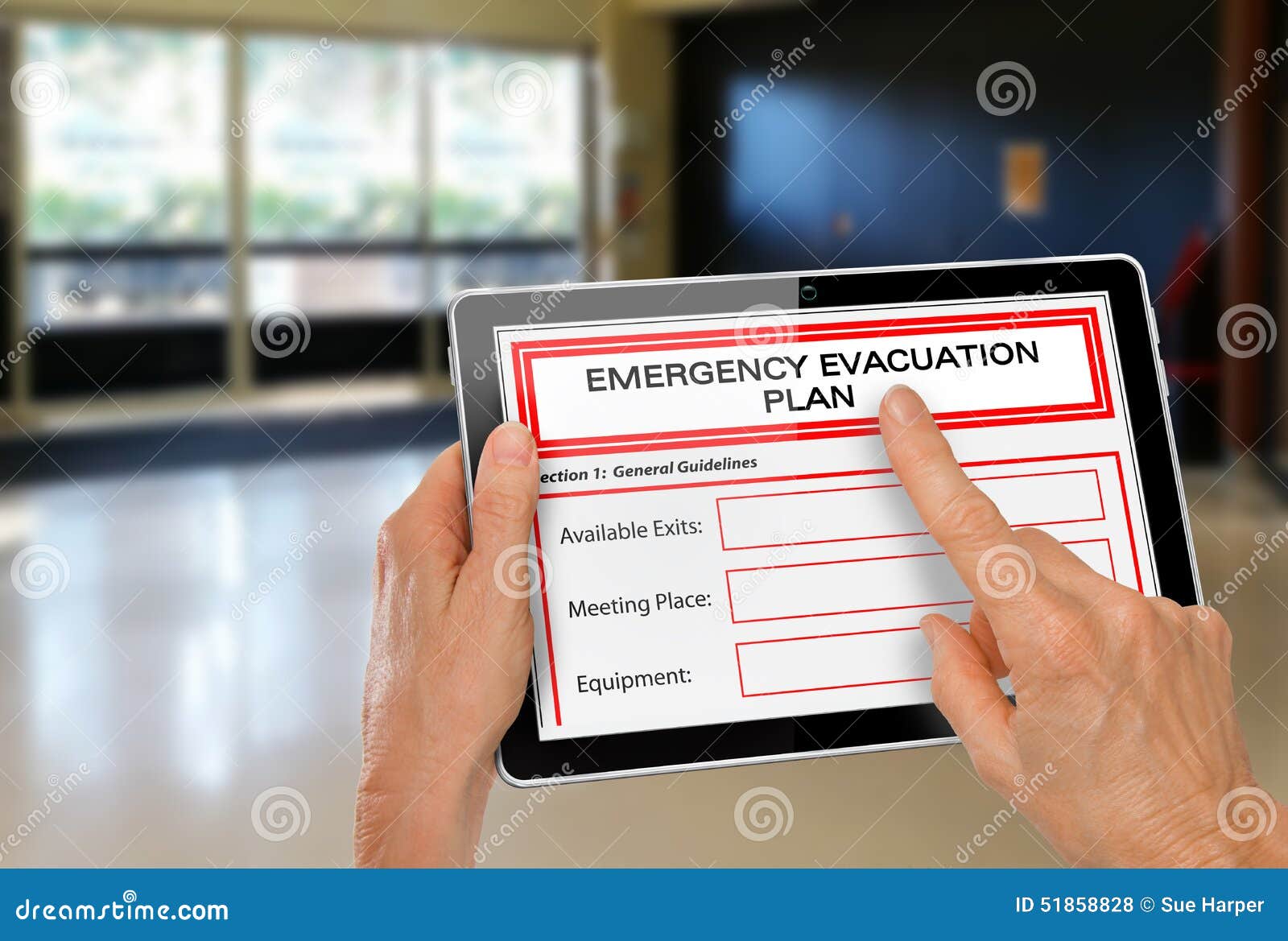 Hands with Computer Tablet and Emergency Evacuation Plan by Doors Stock ...