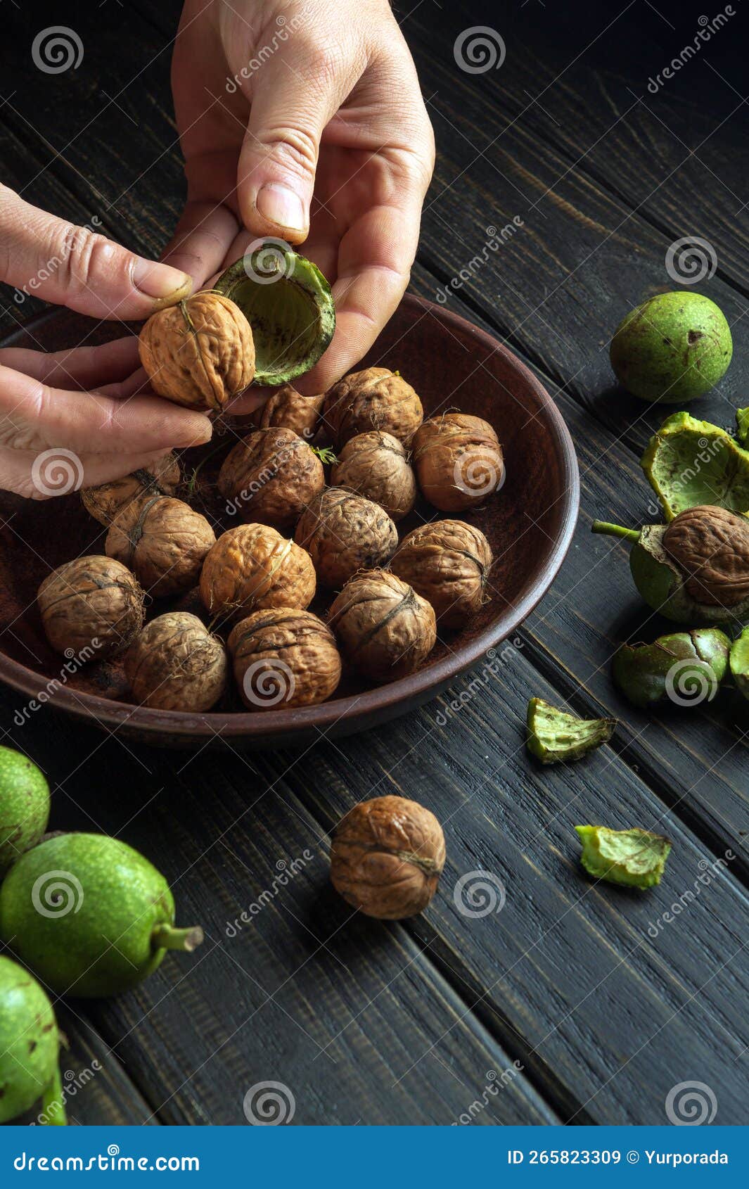 The Hands of the Cook Clean the Walnuts from the Green Peel. Working ...