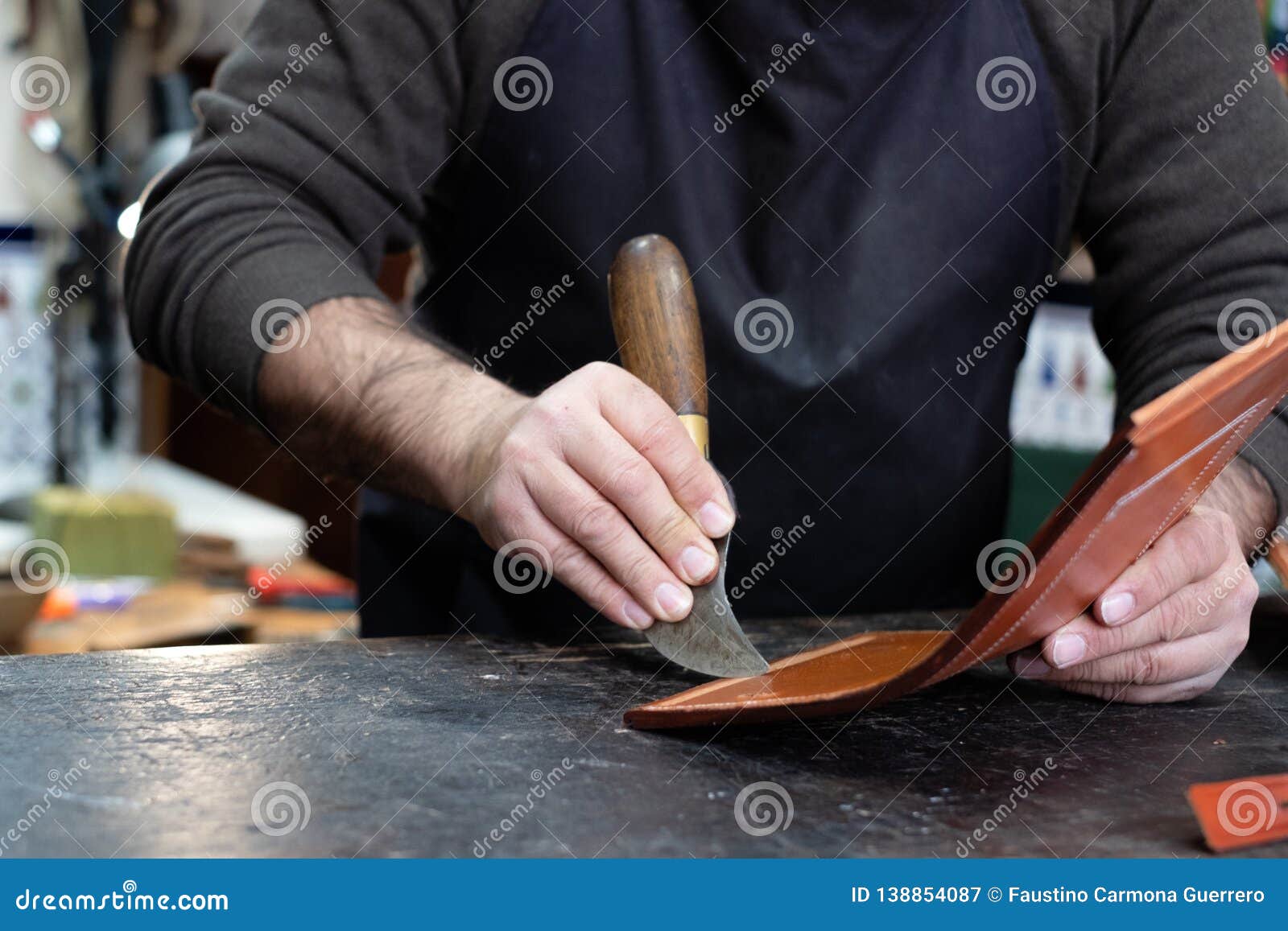 Hands of Craftsman Working the Leather with Special Tool in a Workshop ...