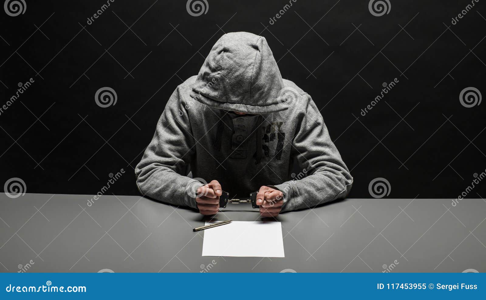 Hands of the Criminal in Handcuffs Write a Handle on Paper. Sincere ...