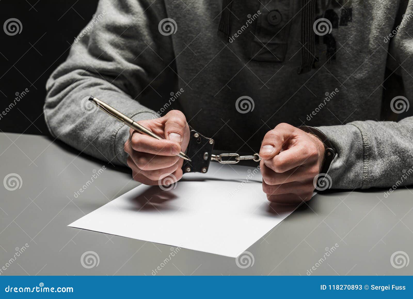 Hands of the Criminal in Handcuffs Write a Handle on Paper. Sincere ...