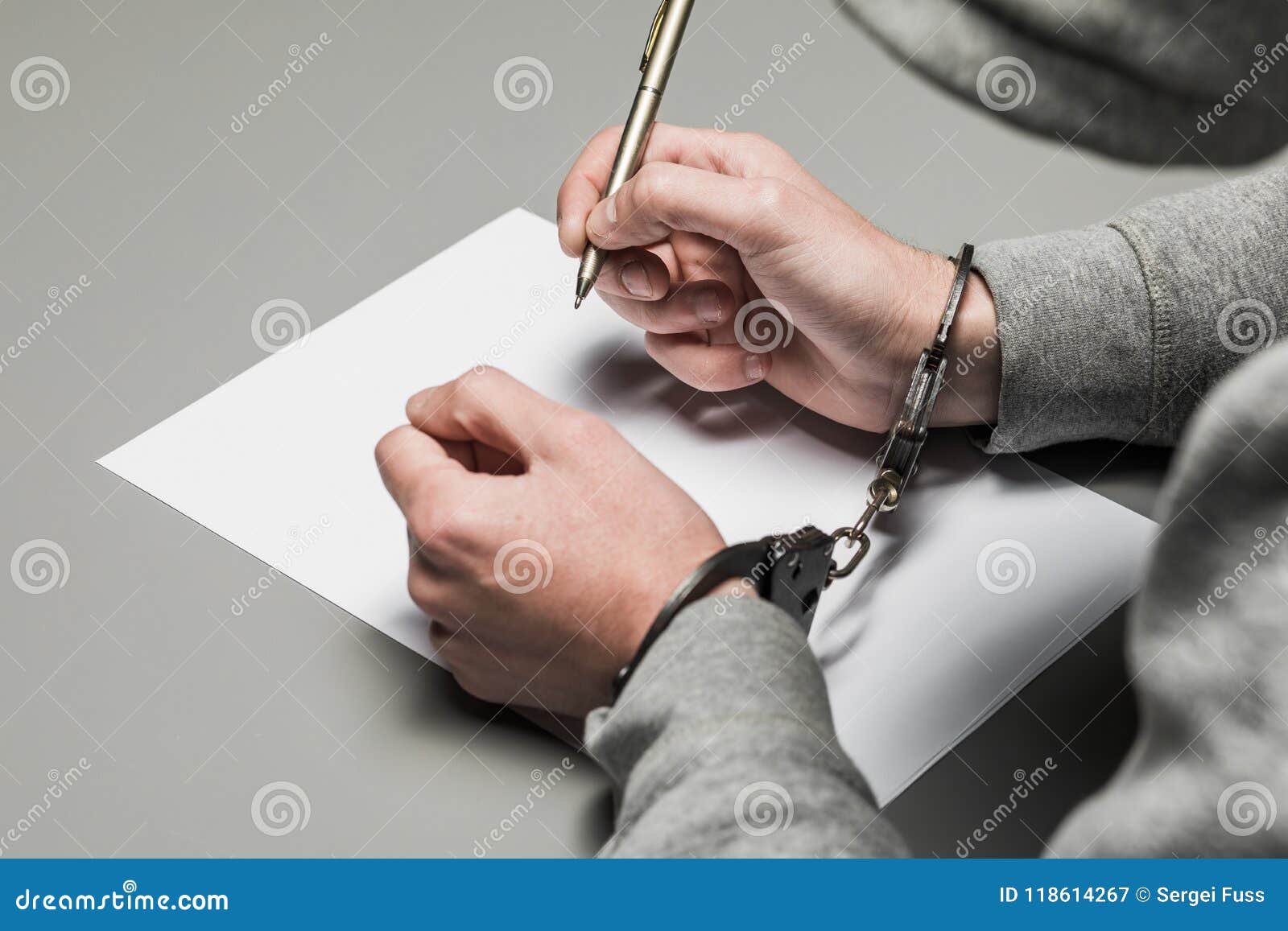 Hands of the Criminal in Handcuffs Write a Handle on Paper. Sincere ...