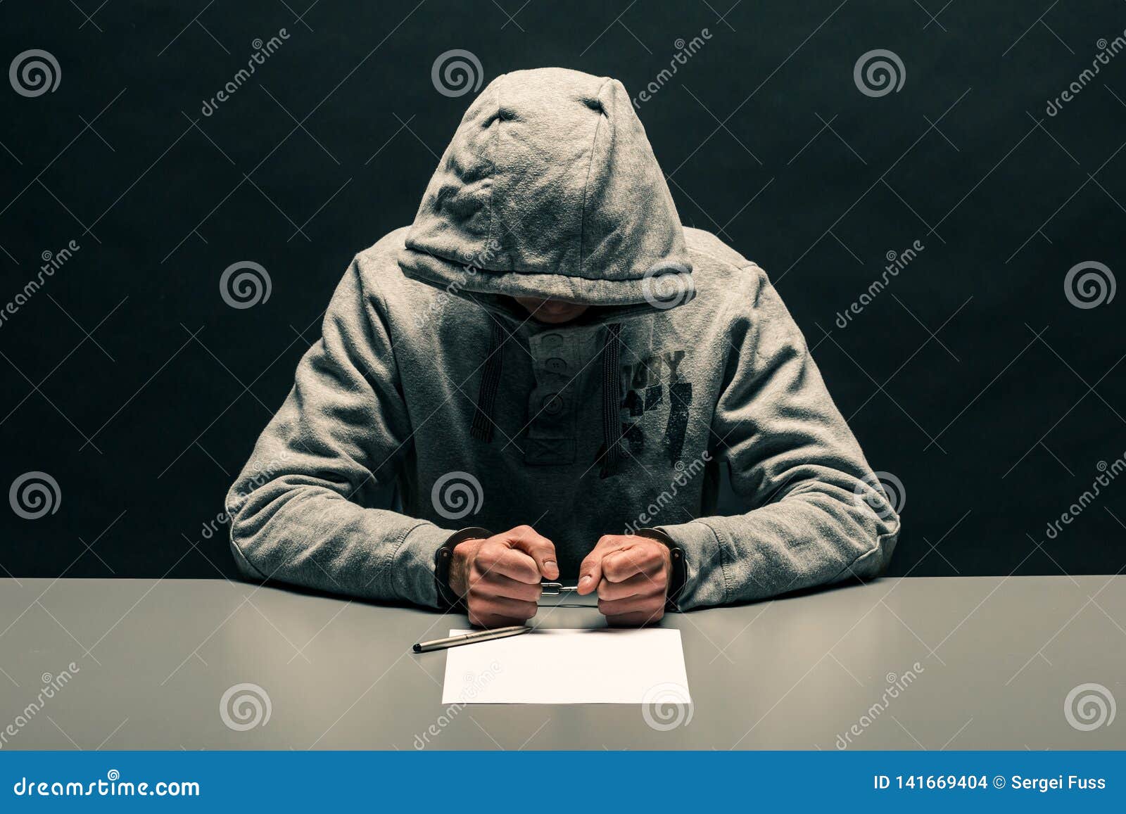 Hands of the Criminal in Handcuffs Write a Handle on Paper. Sincere ...