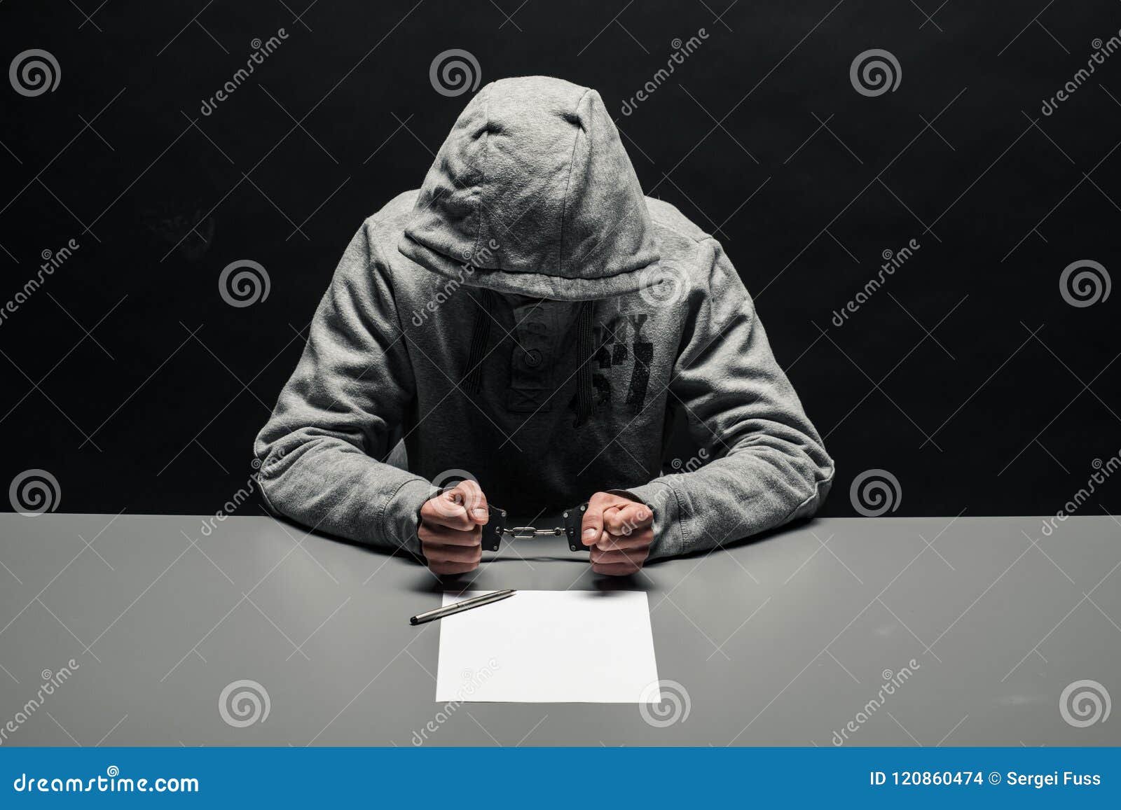 Hands of the Criminal in Handcuffs Write a Handle on Paper. Sincere ...