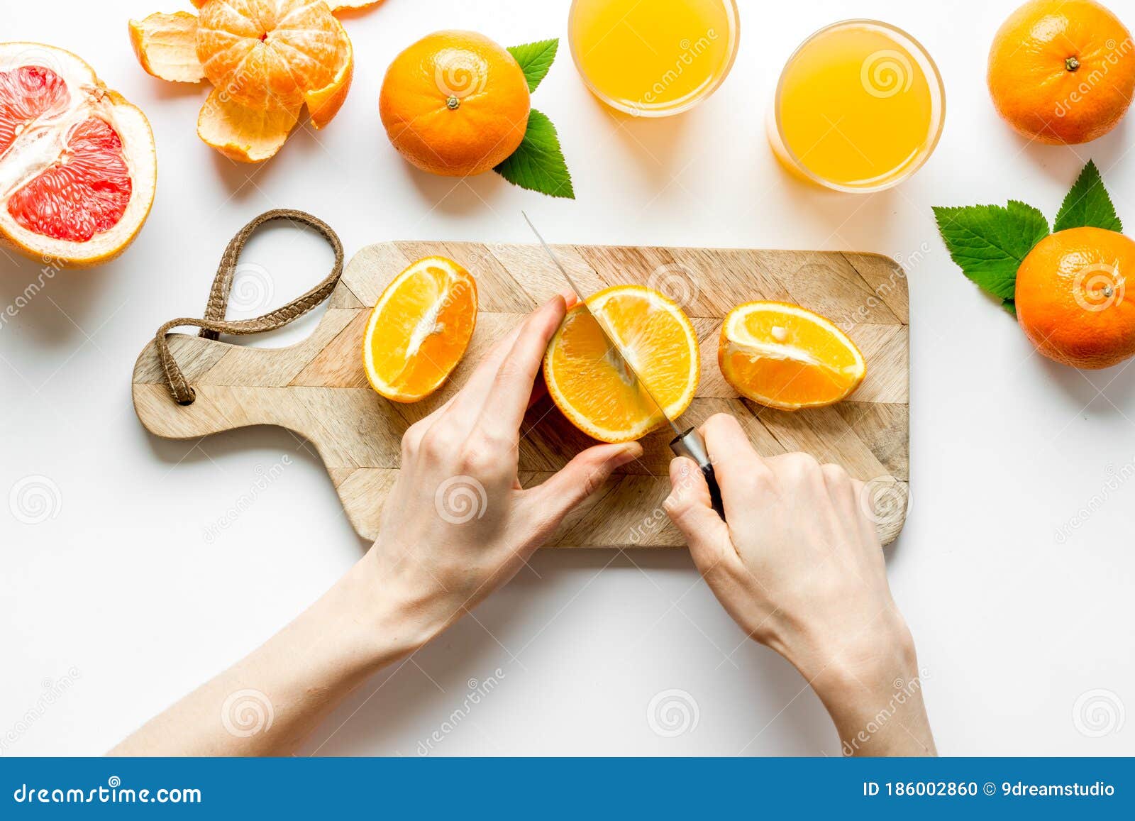 Hands Cutting Citrus Fruit on Board Top View Stock Photo - Image of ...