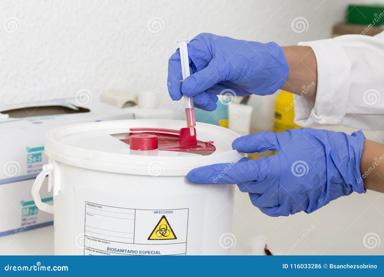 Hands that Deposit a Syringe in the Biohazard Container Stock Photo ...