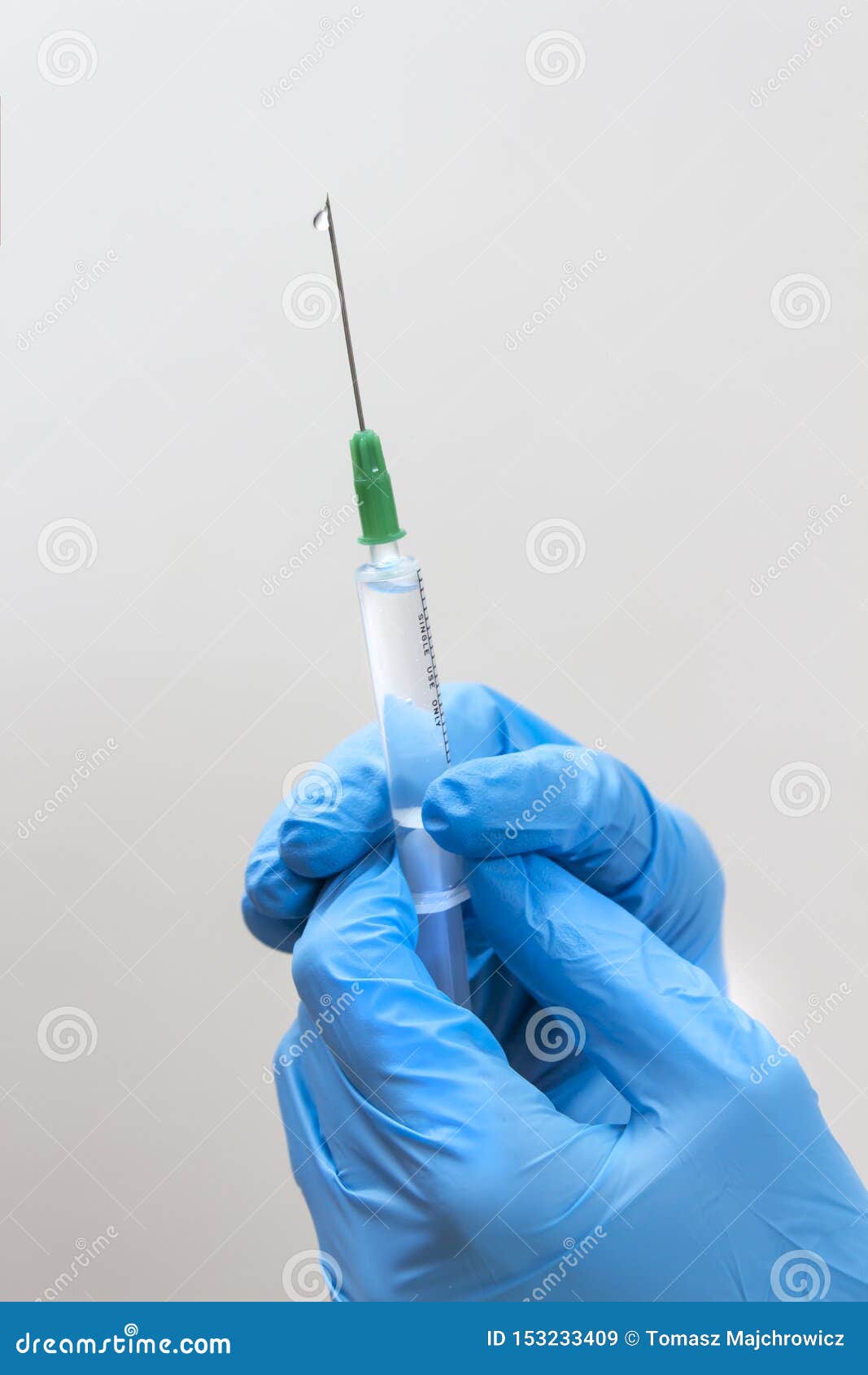 Hands in Disposable Blue Gloves Hold a Syringe and Prepare an Injection ...