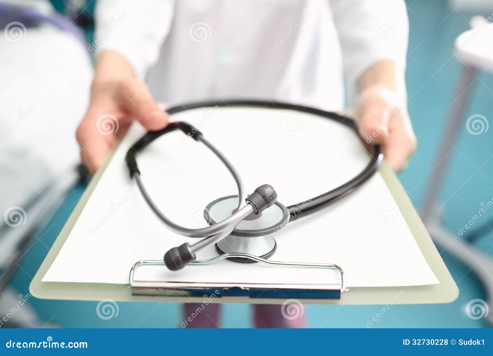 Hands of the Doctor with a Clipboard and a Stethoscope. Stock Photo ...