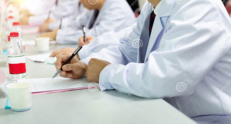 Hands of doctors writing stock image. Image of hand - 292636217