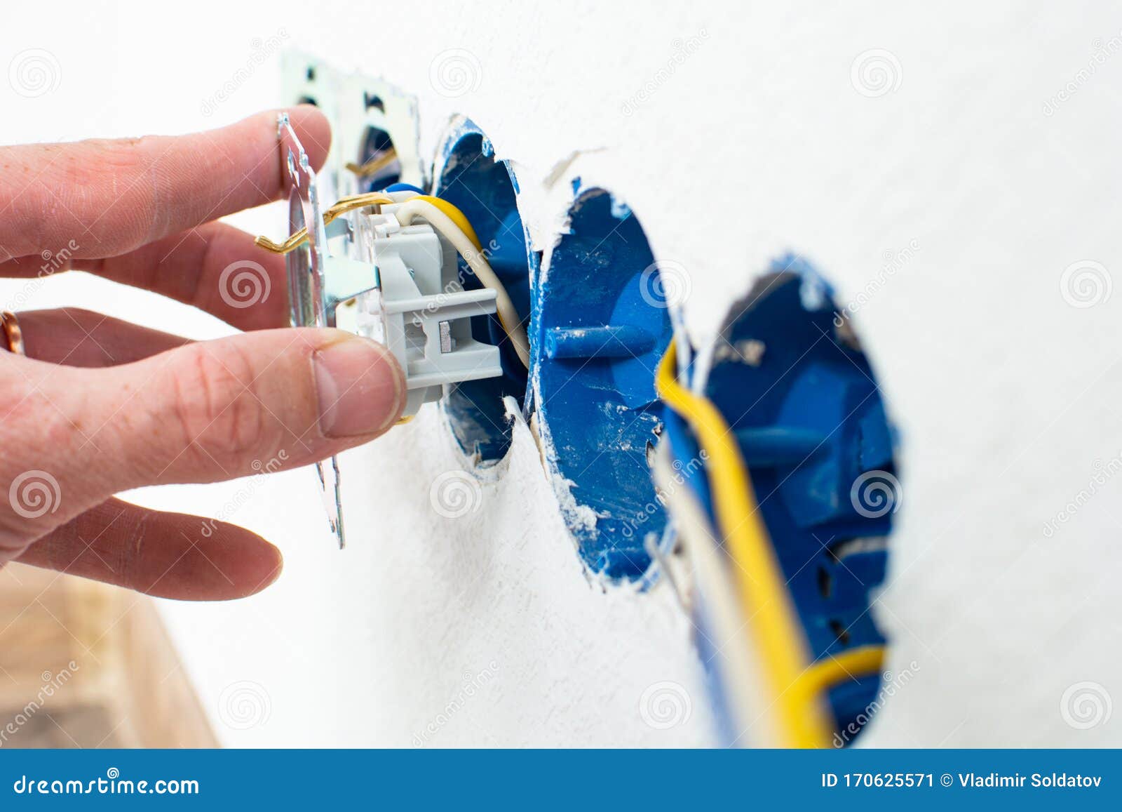 Hands of Electrician Installing Electrical Socket with New Home Stock ...