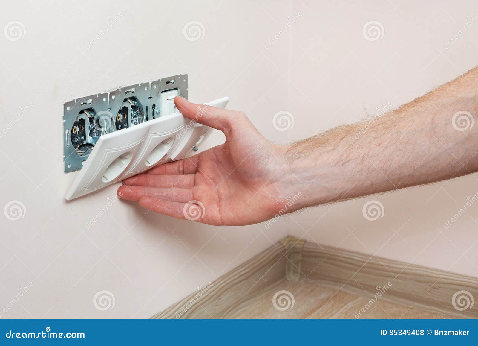 The Hands of an Electrician Installing a Wall Power Socket. Stock Photo ...