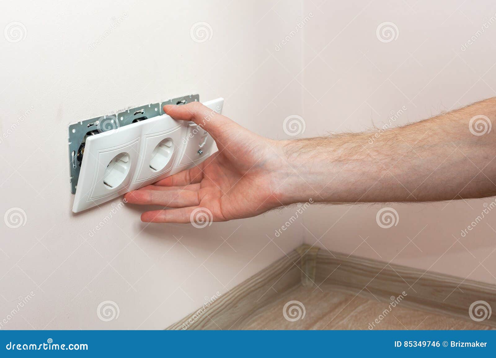 The Hands of an Electrician Installing a Wall Power Socket. Stock Photo ...