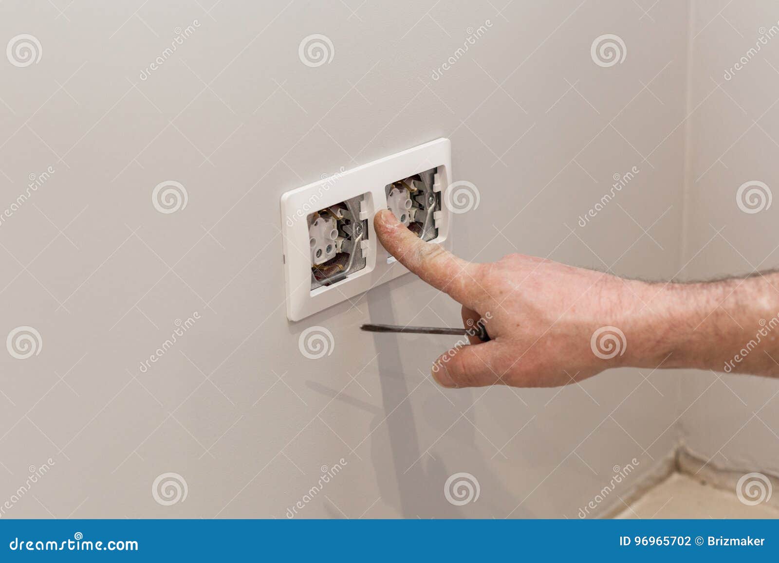 The Hands of an Electrician Installing a Wall Power Socket. Stock Photo ...