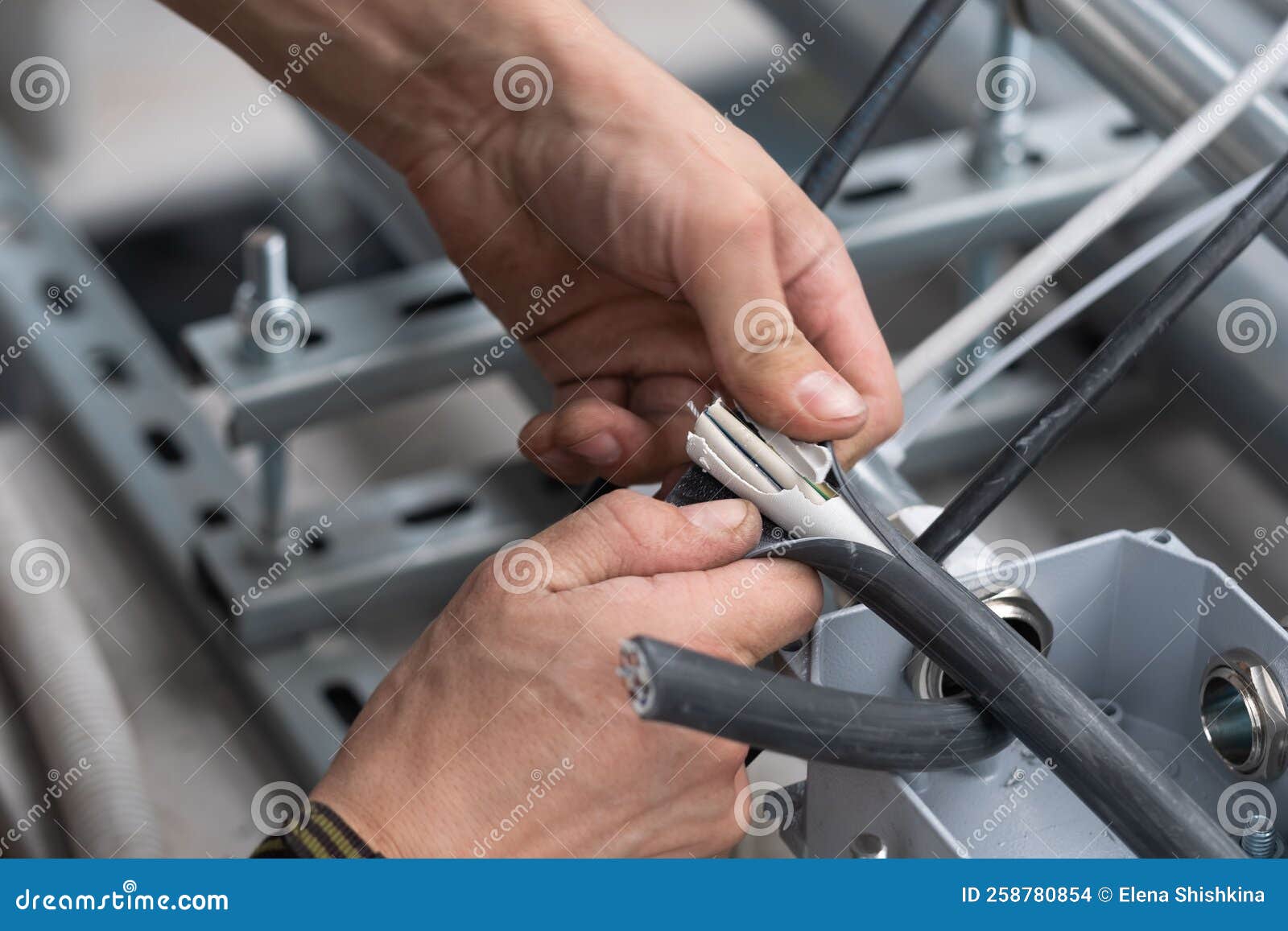 The Hands of an Electrician Strips the Ends of the Cable To Connect To ...