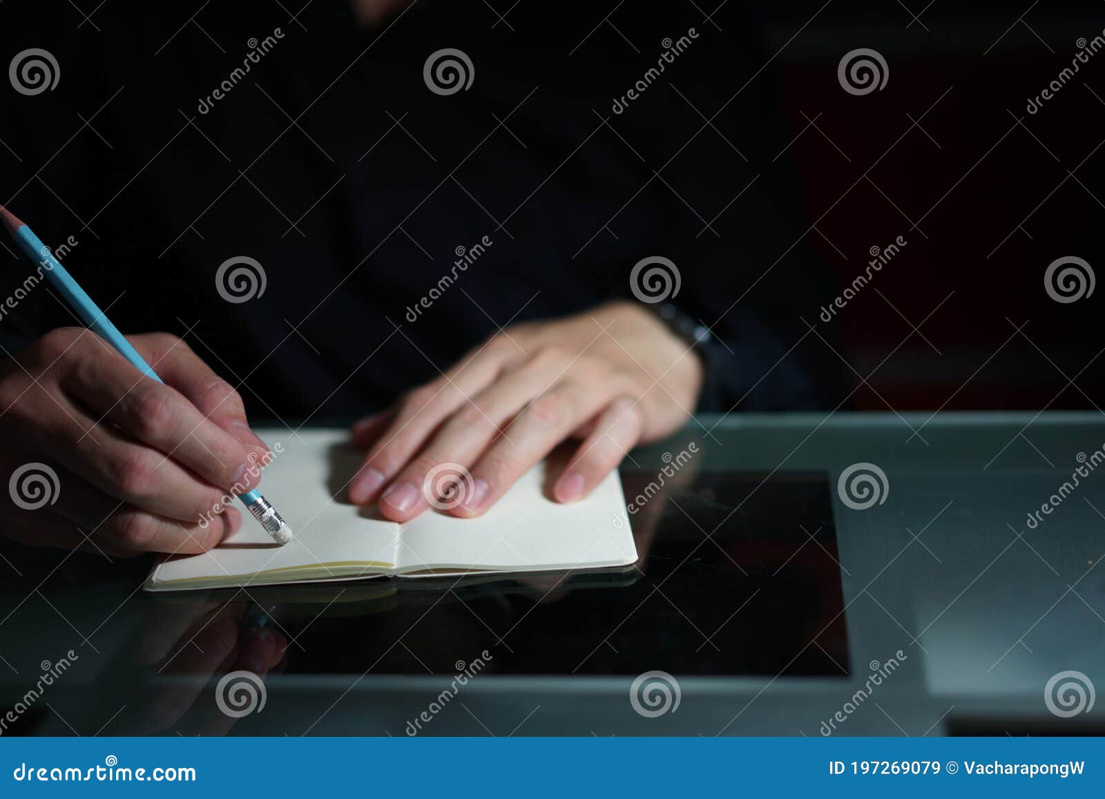 Hands Erase on Notepad by Pencil in Light in Dark Stock Image - Image ...