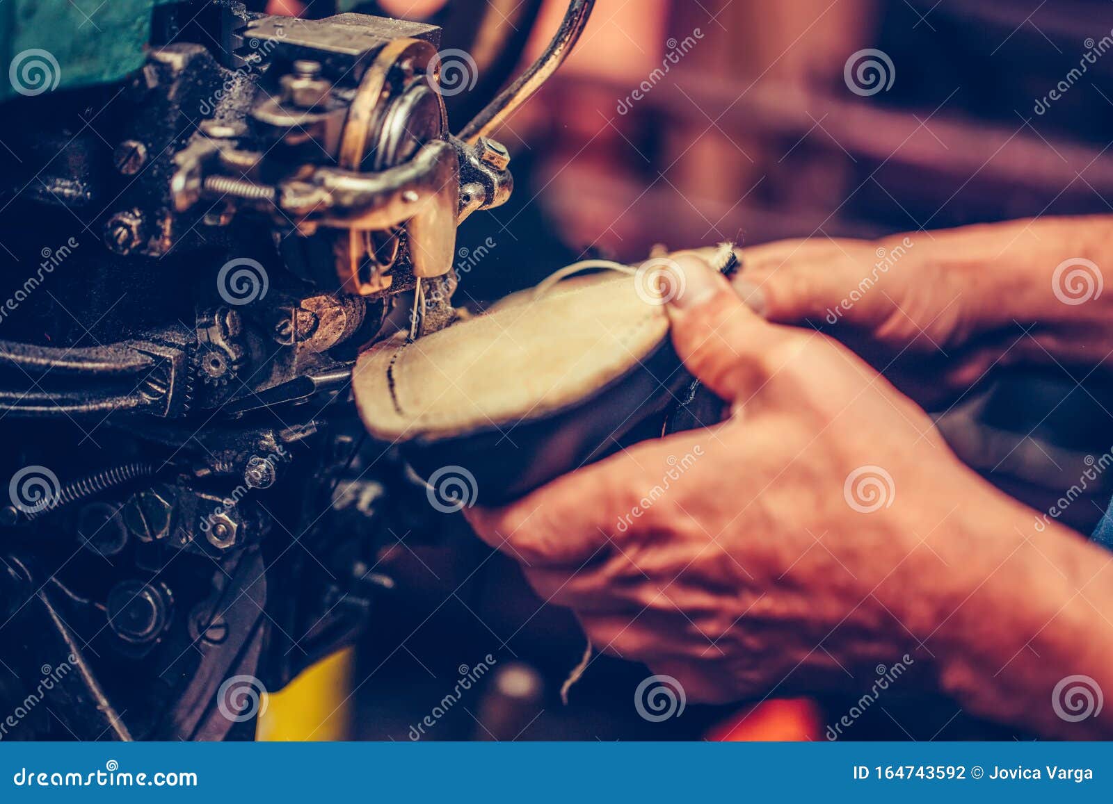 Hands of an Experienced Shoemaker Stitching a Part of the Shoe in a ...