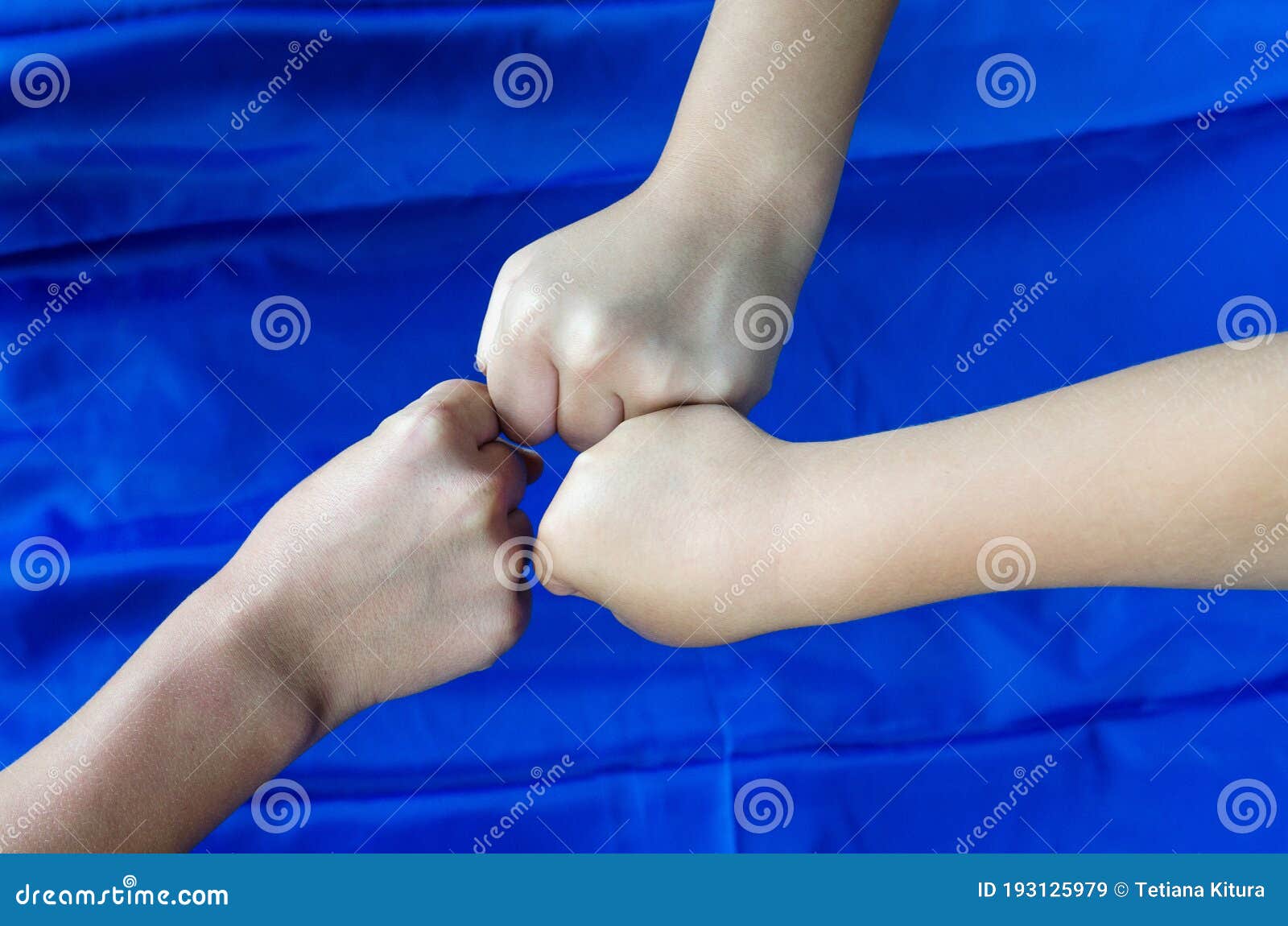 Three Hands Fists Together on a Blue Background. Stock Image - Image of ...