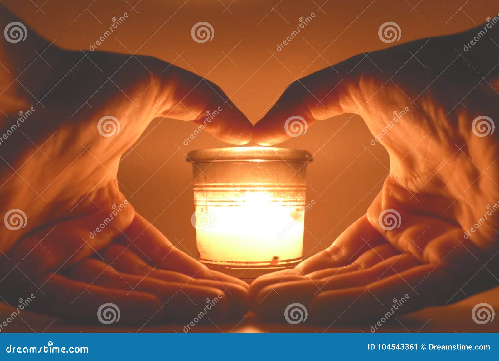 Hands Forming a Hearth in Front of the Light of a Candle Stock Image ...