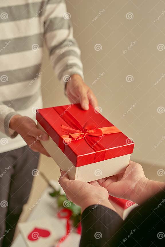 Hands Giving and Receiving a Red Present Stock Image - Image of home ...