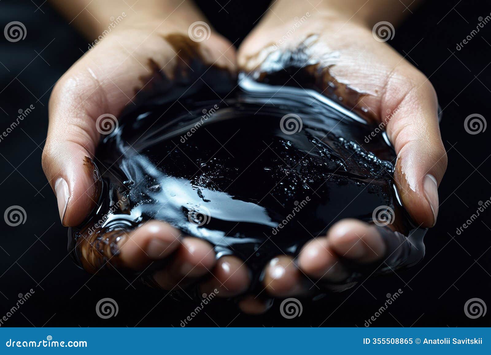 Close Up View of Hands Holding Black Crude Oil on a Dark Background ...