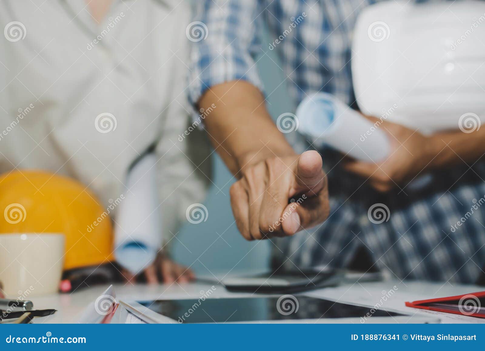 Group Of Engineer Checking The Blueprint On The Table And Talking About ...