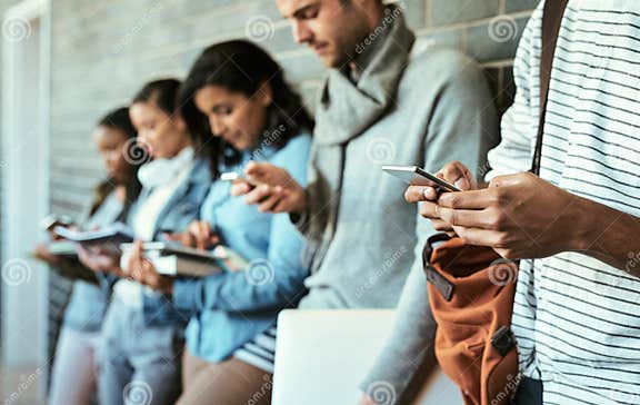 Hands, Group and Student with Technology, Textbooks and Diversity in Corridor for Lecture or ...