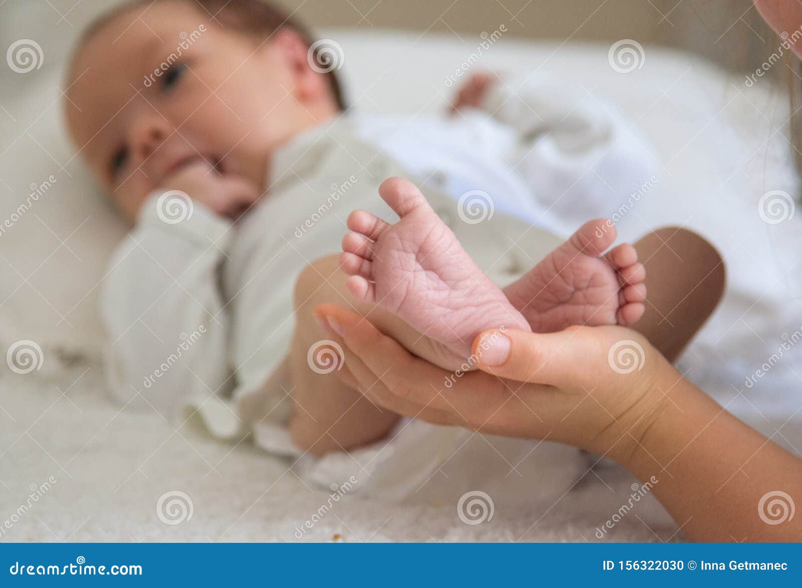 Hands Hold the Foot of a Newborn Baby Stock Photo - Image of family ...