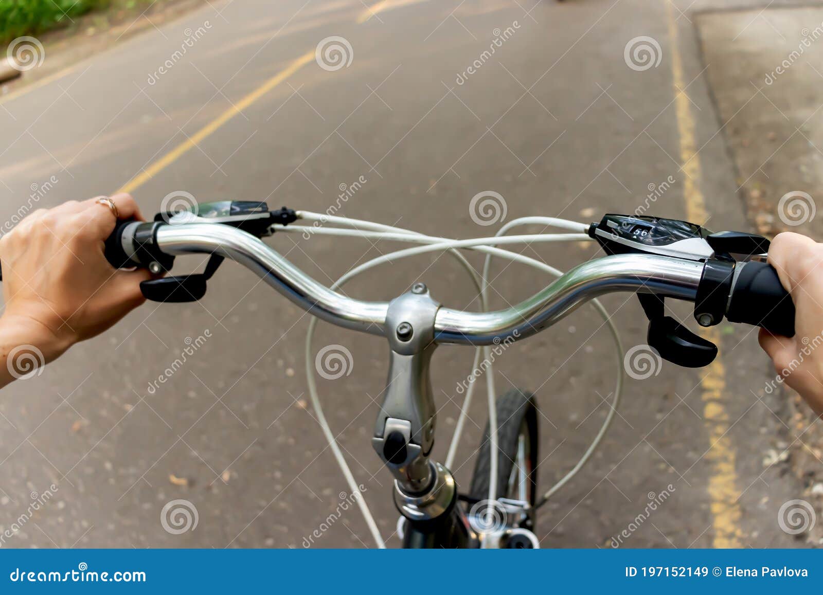 Hands Hold the Handlebars of the Bike. the Bike Rides on the Sidewalk ...