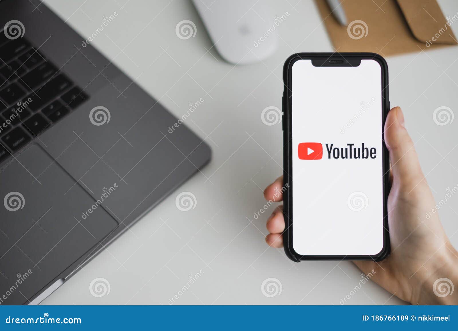 Hands Hold the IPhone with Youtube App Logo on the Screen. Editorial ...