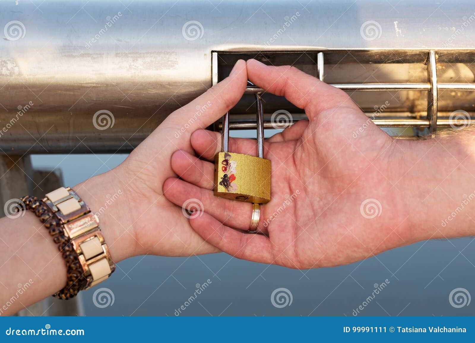 The Hands Hold the Lock Buttoned on the Railing of the Bridge Stock ...