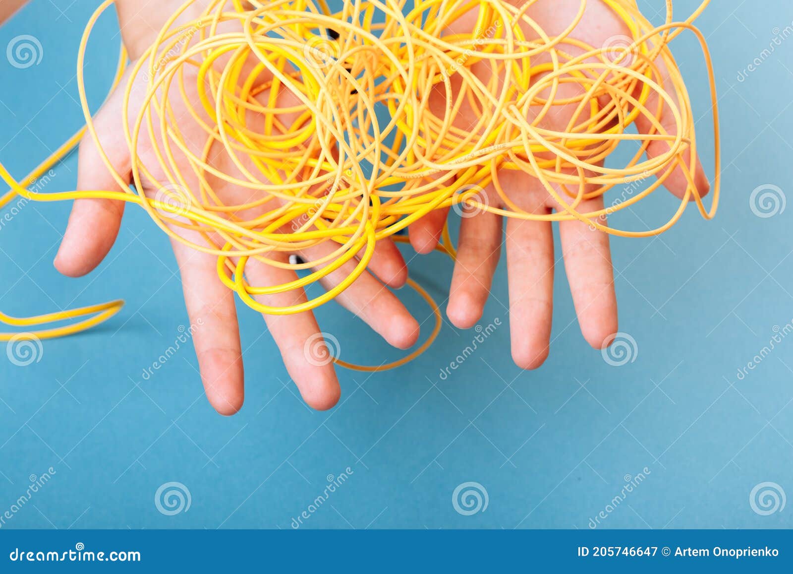 Hands Hold the Mess of Optical Fiber. Isolated on Blue Stock Image ...