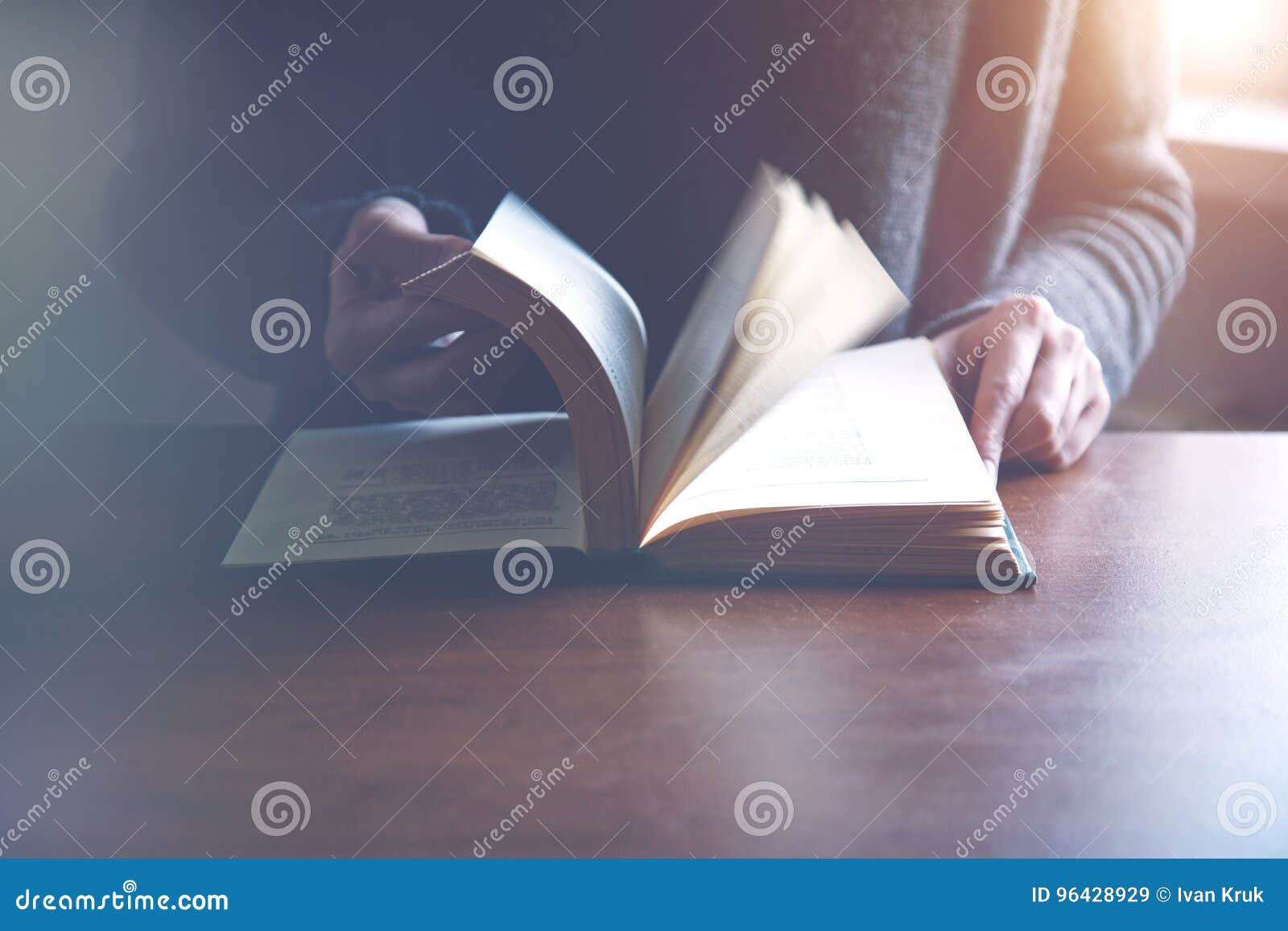 Hands Holding Book and Reading Stock Image - Image of paper, room: 96428929