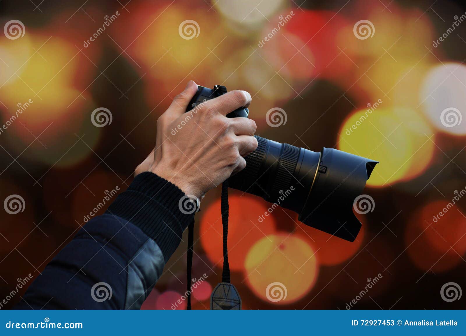 Hands Holding a Camera with Blurred Lights Stock Image - Image of ...