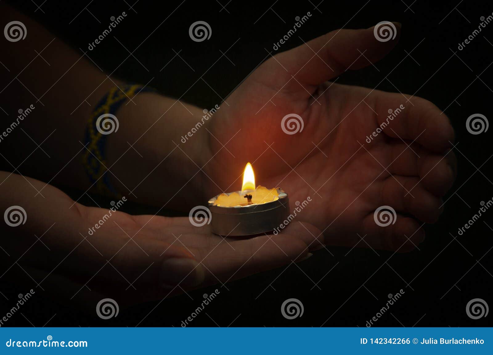 Hands holding candle light stock photo. Image of candlelight - 142342266