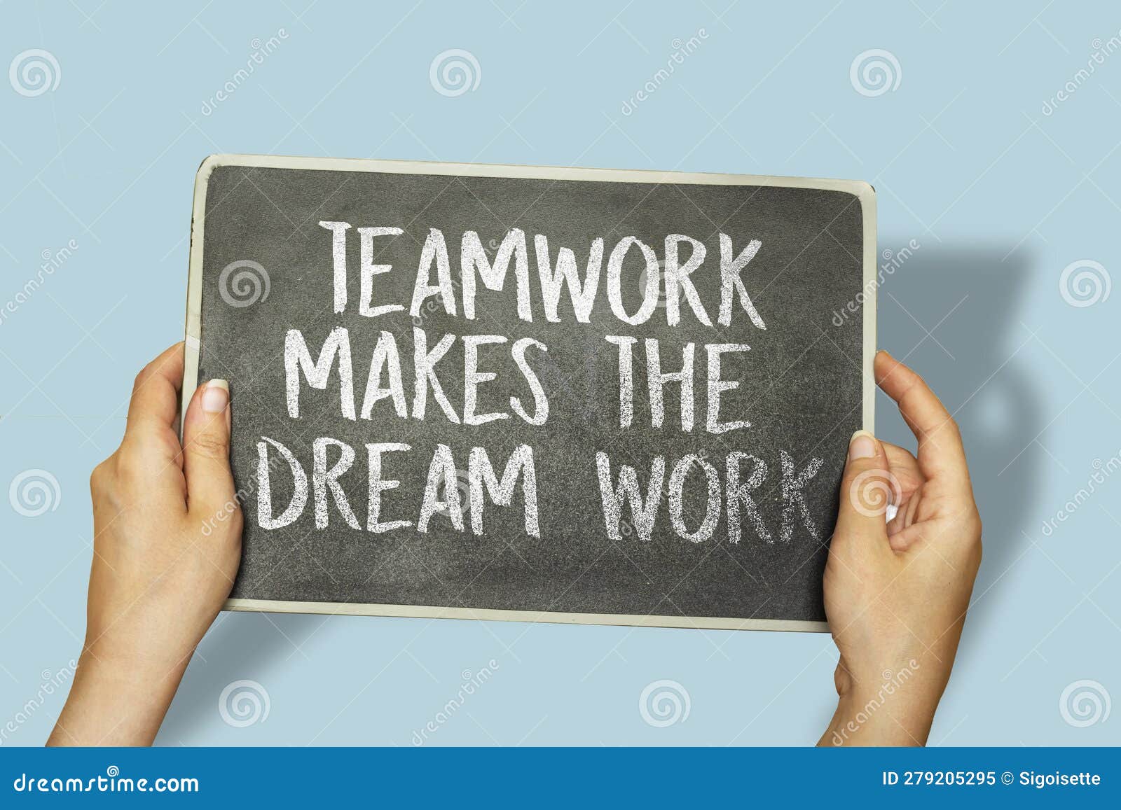 Hands Holding a Chalkboard with Teamwork Makes the Dream Work Concept ...
