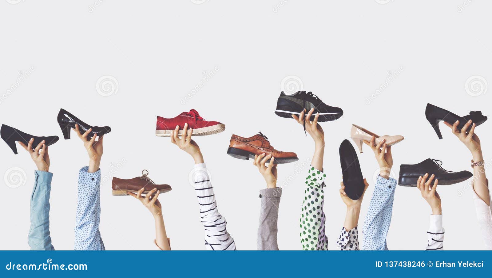 Hands Holding Different Shoes on Isolated Background Stock Photo ...